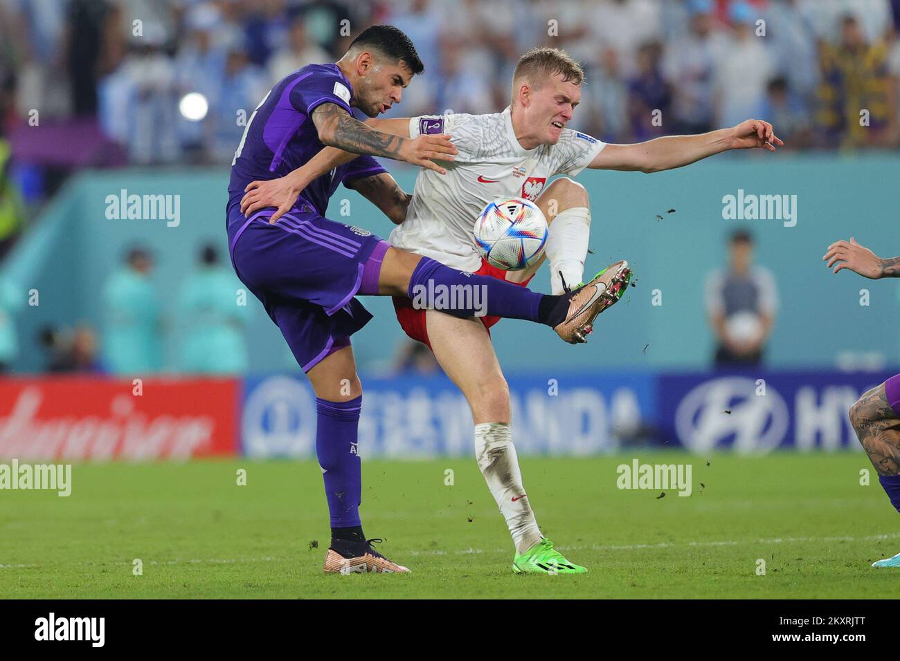 Doha, Qatar. 30th Nov, 2022. Karol Swiderski of Poland is challenged by ...