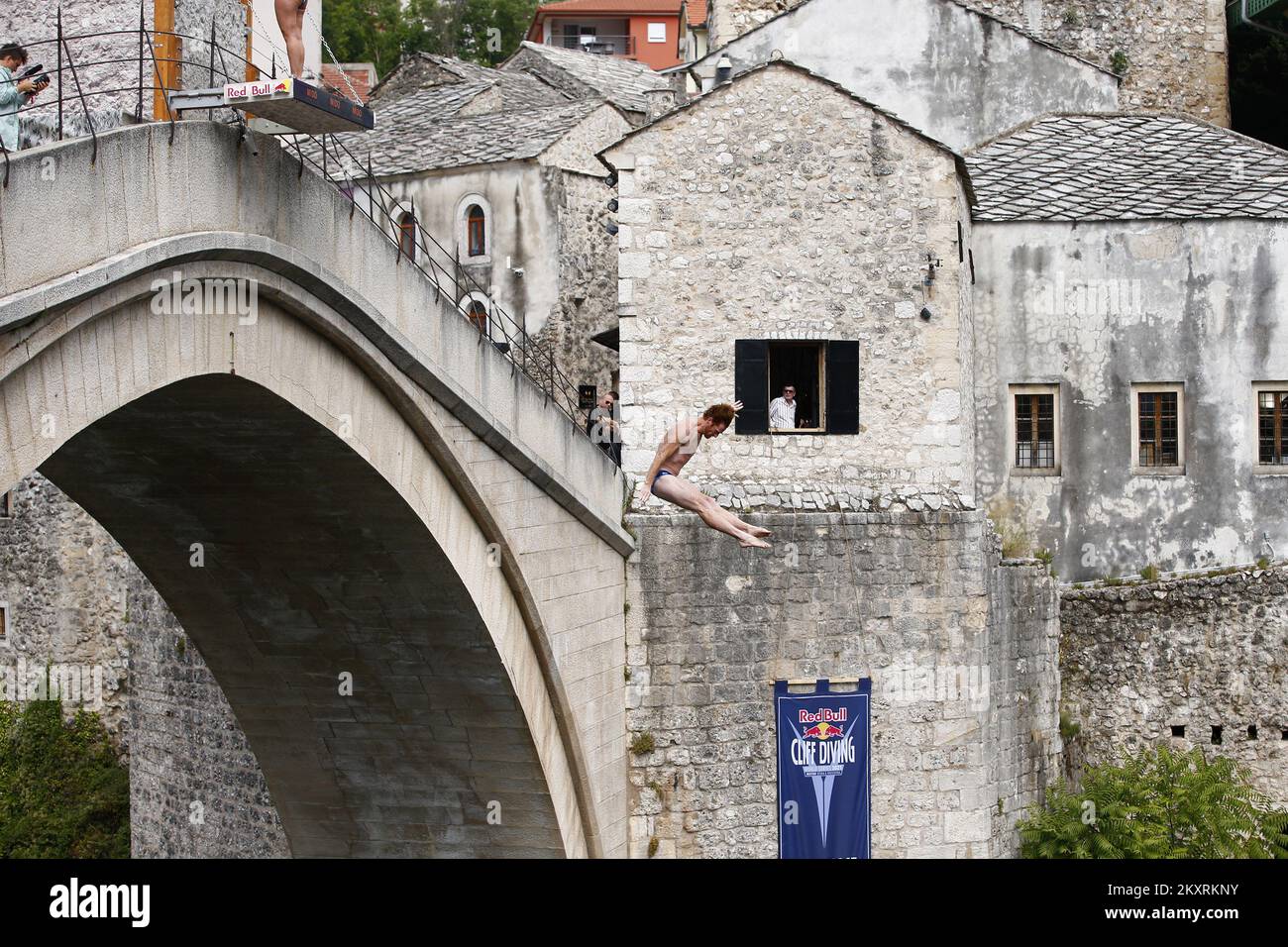 The competitor jumps from the Old Bridge as part of the Red Bull Cliff ...