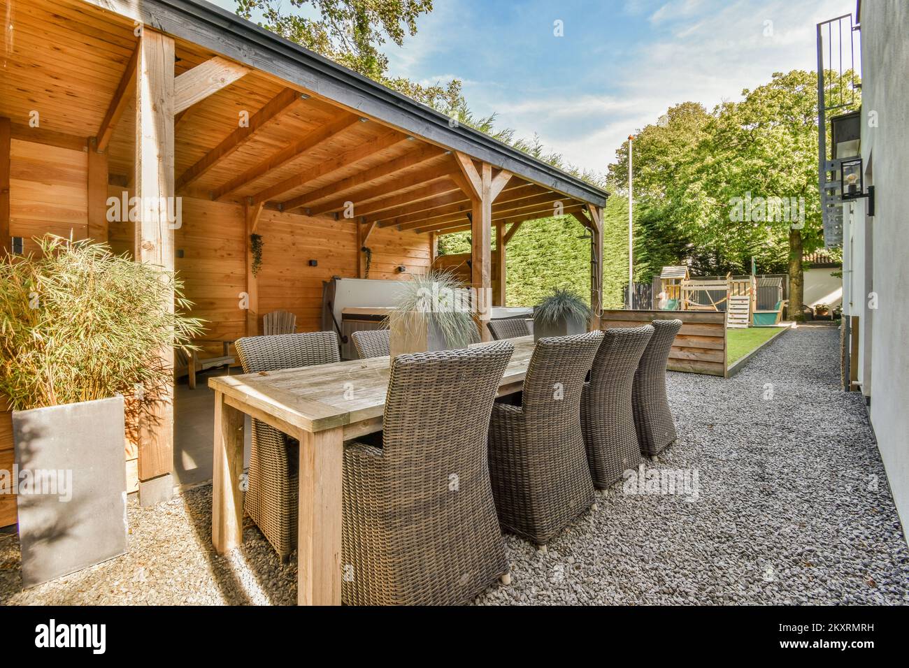 Neat powerful patio with sitting area and small garden near wooden ...