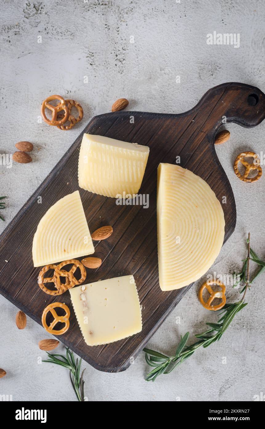 Assorted tasty cheese of different kinds and sizes on table. cheese ...
