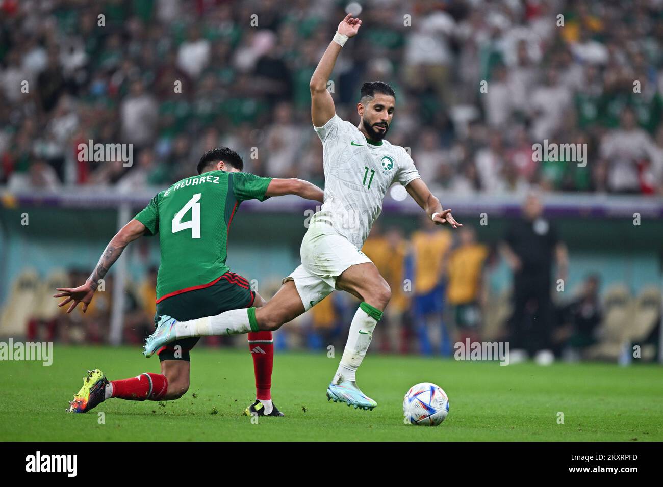 Lusail, Qatar. 30th Nov, 2022. Saleh Alshehri (R) of Saudi Arabia vies ...