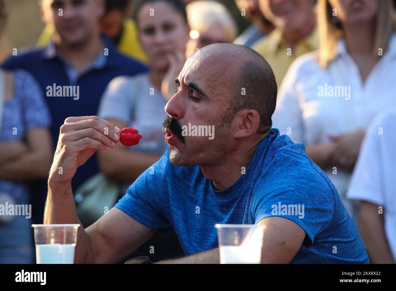The contestant eats chilli pepper during the competition in Zagreb on ...