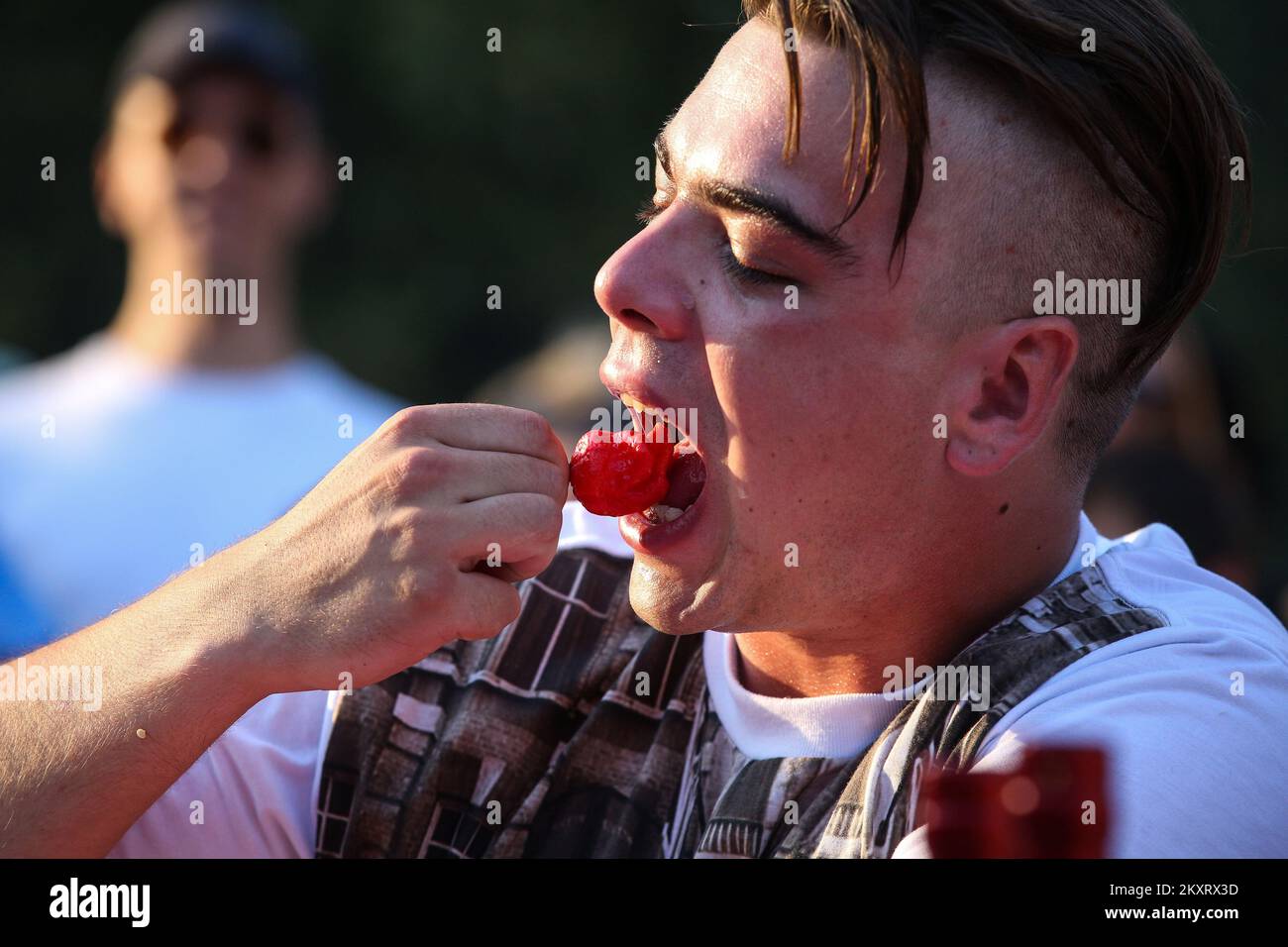 The contestant eats chilli pepper during the competition in Zagreb on ...