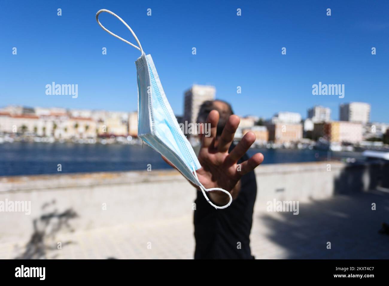 A man outside throwing mask in Zadar, Croatia on September 23, 2021 ...