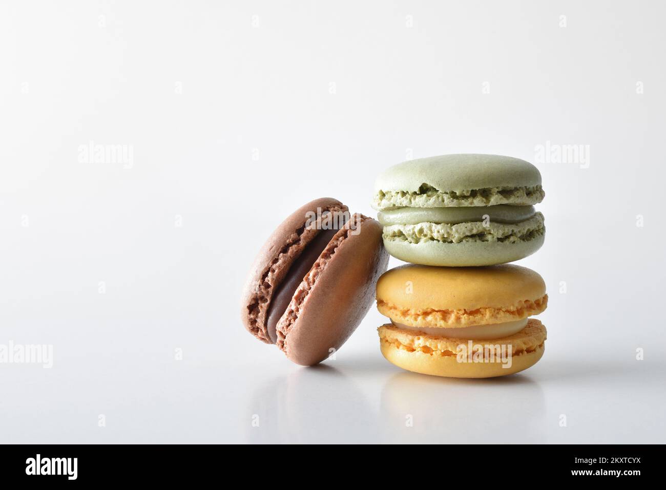 Stack of three flavor french macaroon reflected on white table and ...