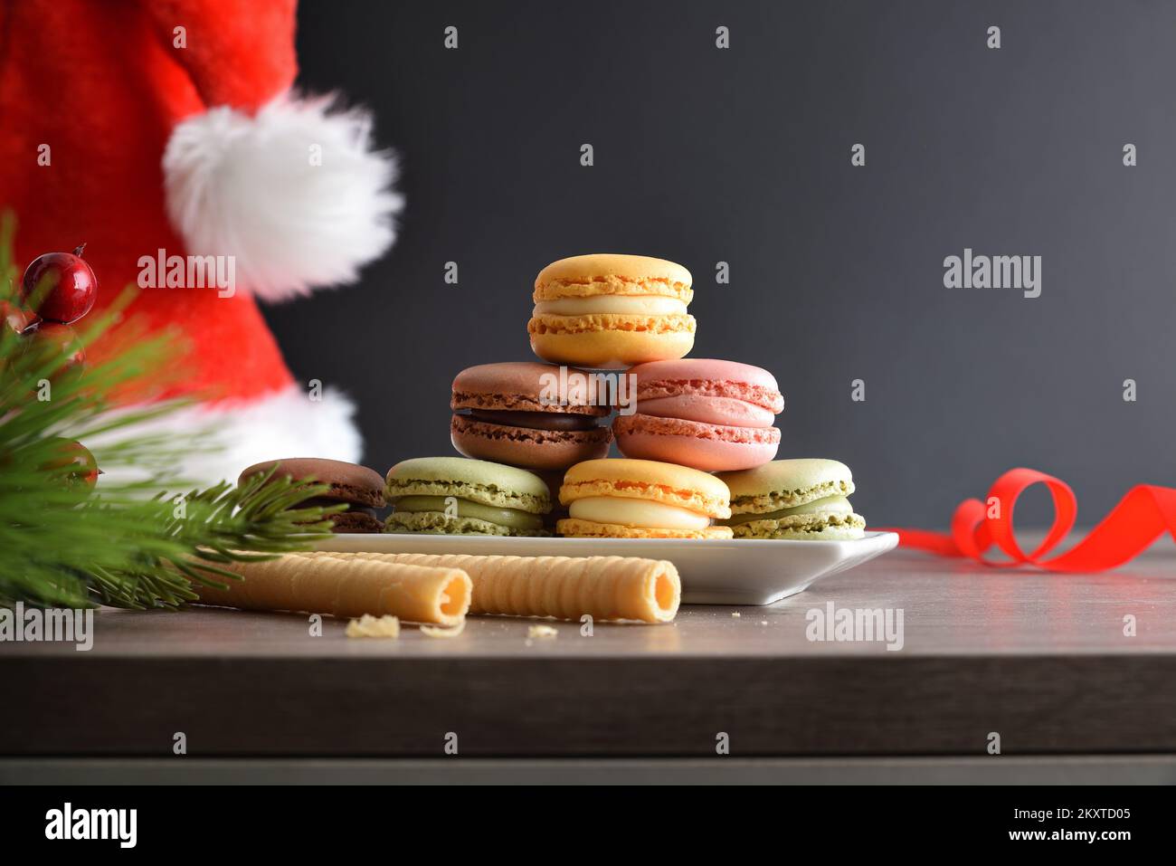 Stack of various flavors french macaroons served on white plate on ...
