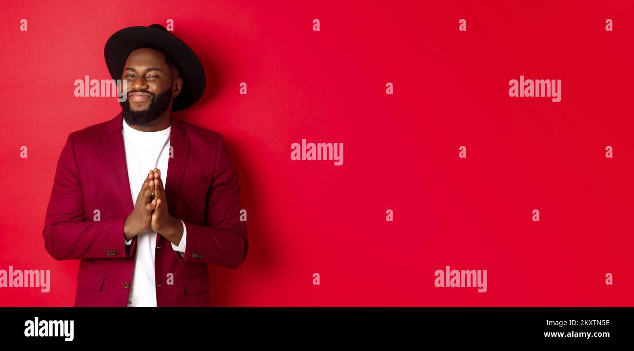 Handsome successful Black man relish profit, rub hands and smiling ...