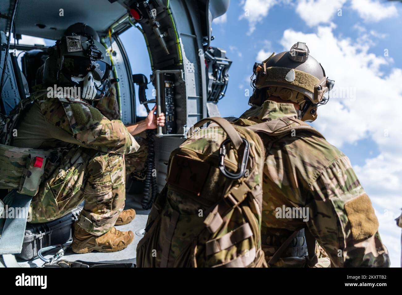 A U.S. Air Force Special Mission Aviator aboard an HH-60W Jolly Green ...