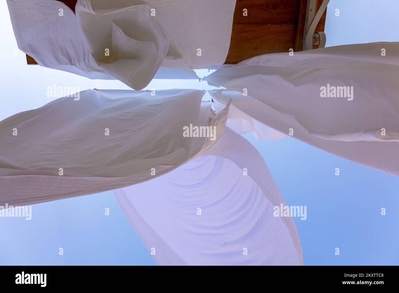 White linen drying on clothesline in fishing village of Symi, Island in ...