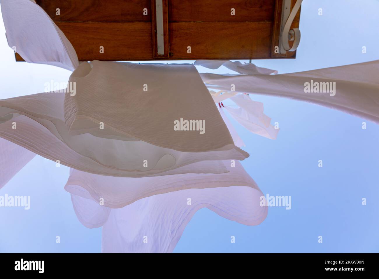 White linen drying on clothesline in fishing village of Symi, Island in ...