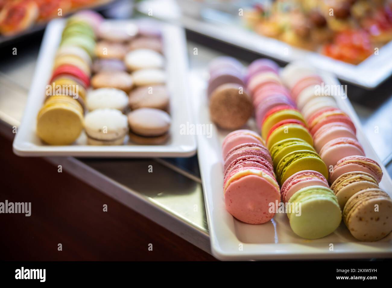 Colorful french macaroons on a glossy white plate ready for a food ...