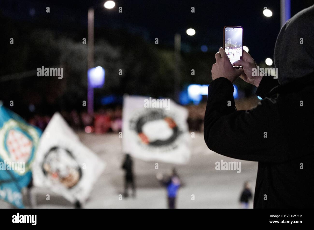 A man photographs flags and a Torcida Split parade on Vukovarska Street ...