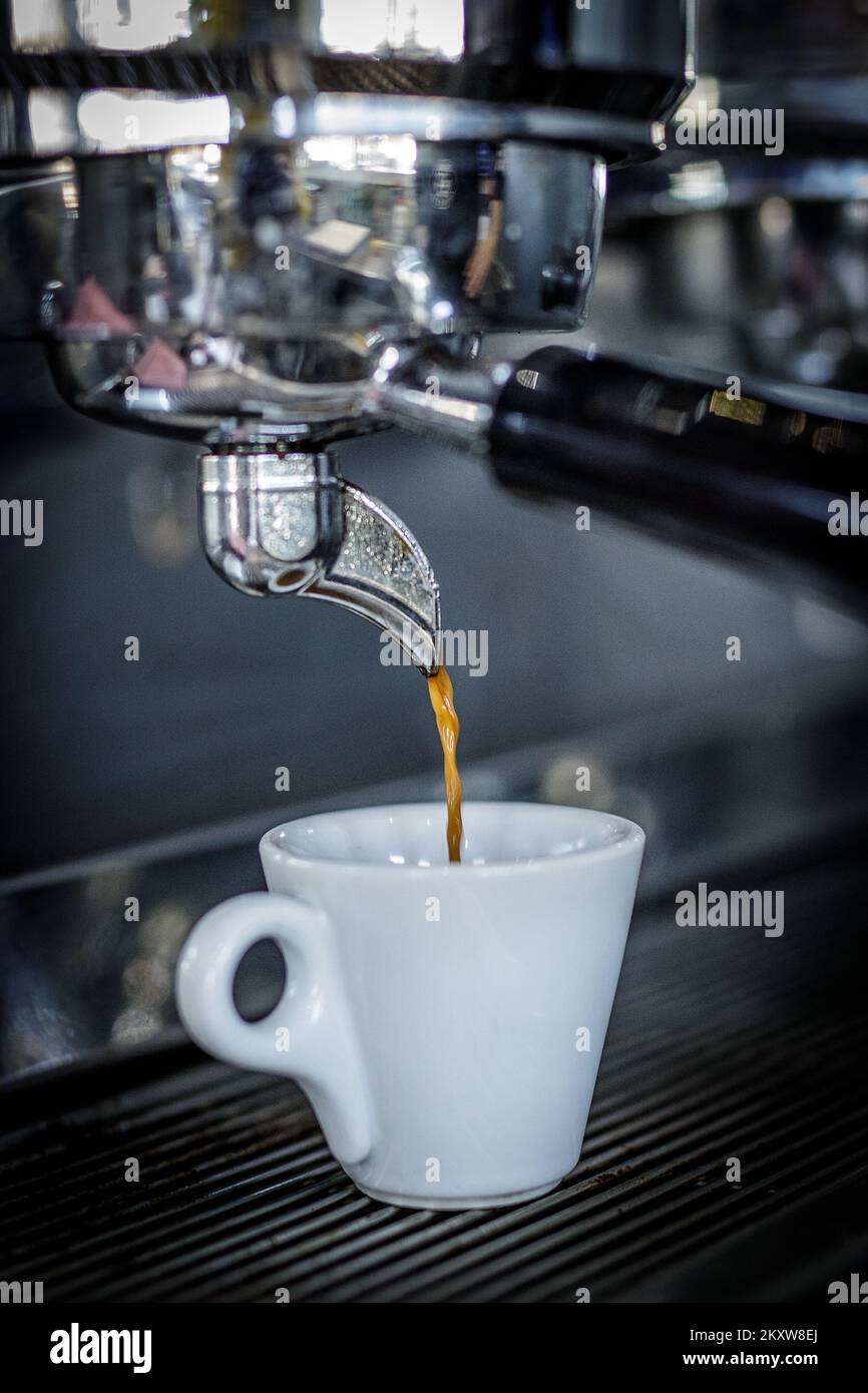 Fresh espresso shot pouring out of machine. Photo: Davor Puklavec ...