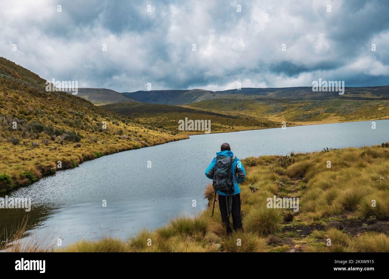 Rear view of a hiker at Lake Ellis, Chogoria Route, Mount Kenya ...