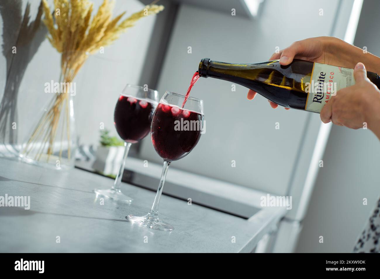 Womans hand pouring wine hi-res stock photography and images - Alamy
