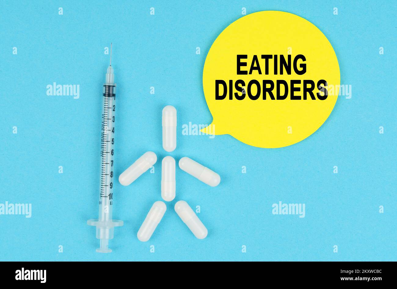 Medicine and health concept. Syringe, human figure made of pills and ...