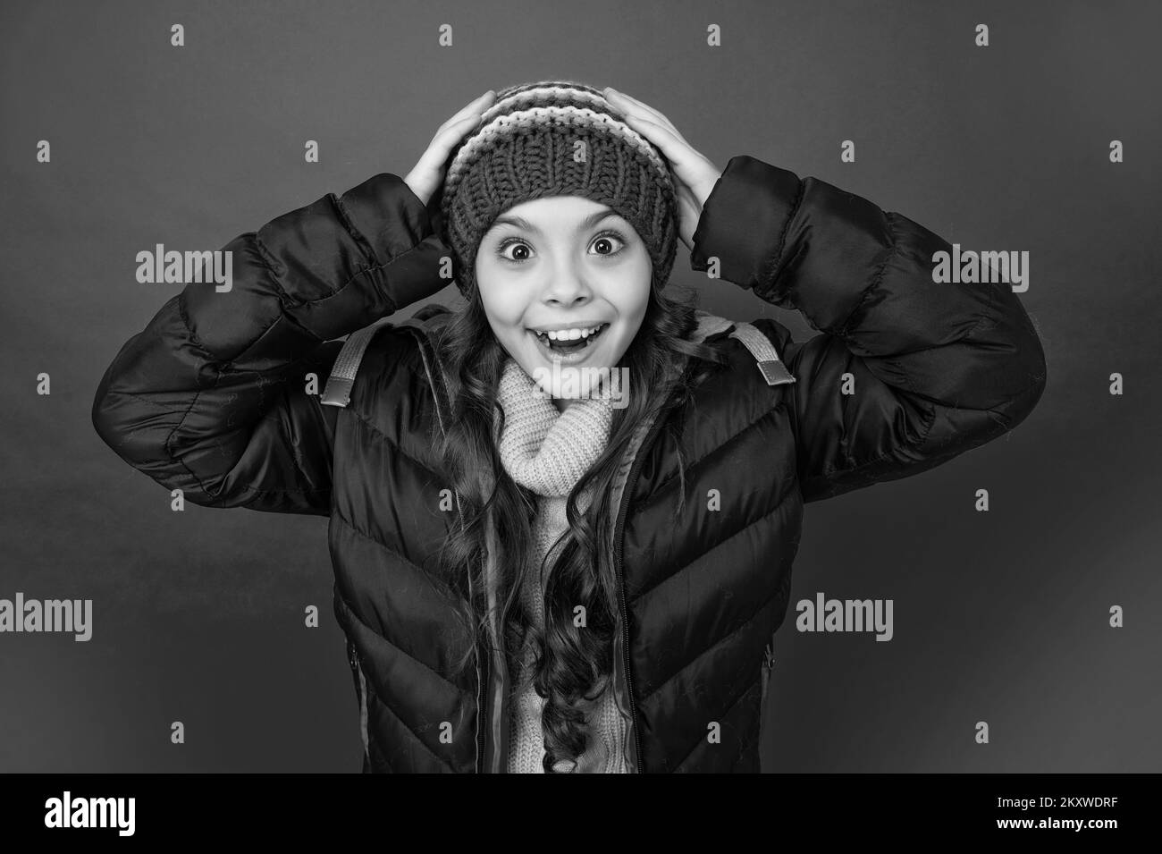 express positive emotion. winter fashion. amazed kid with curly hair ...