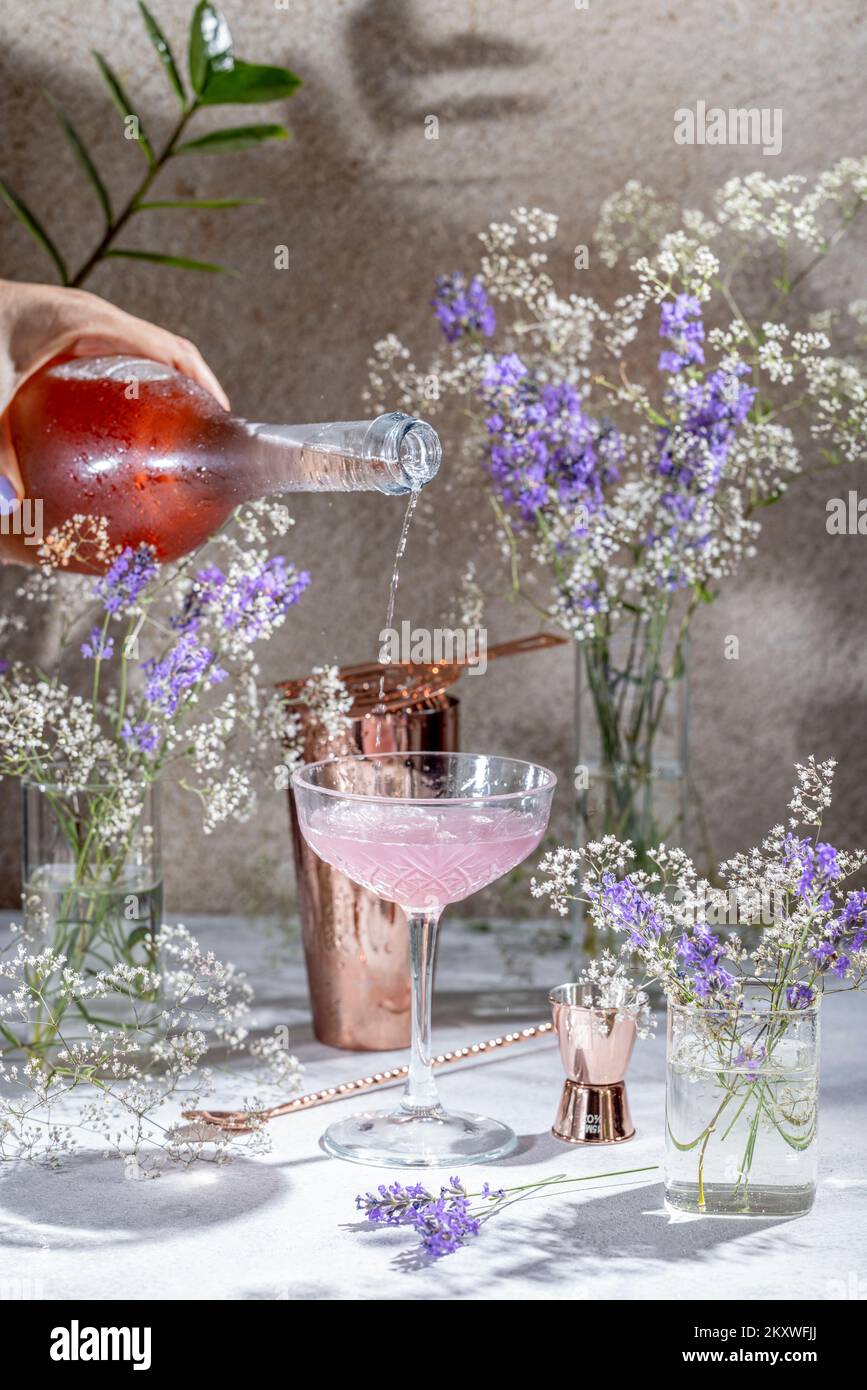 Elegant glass of Lavender Cocktail or mocktails surrounded by ...