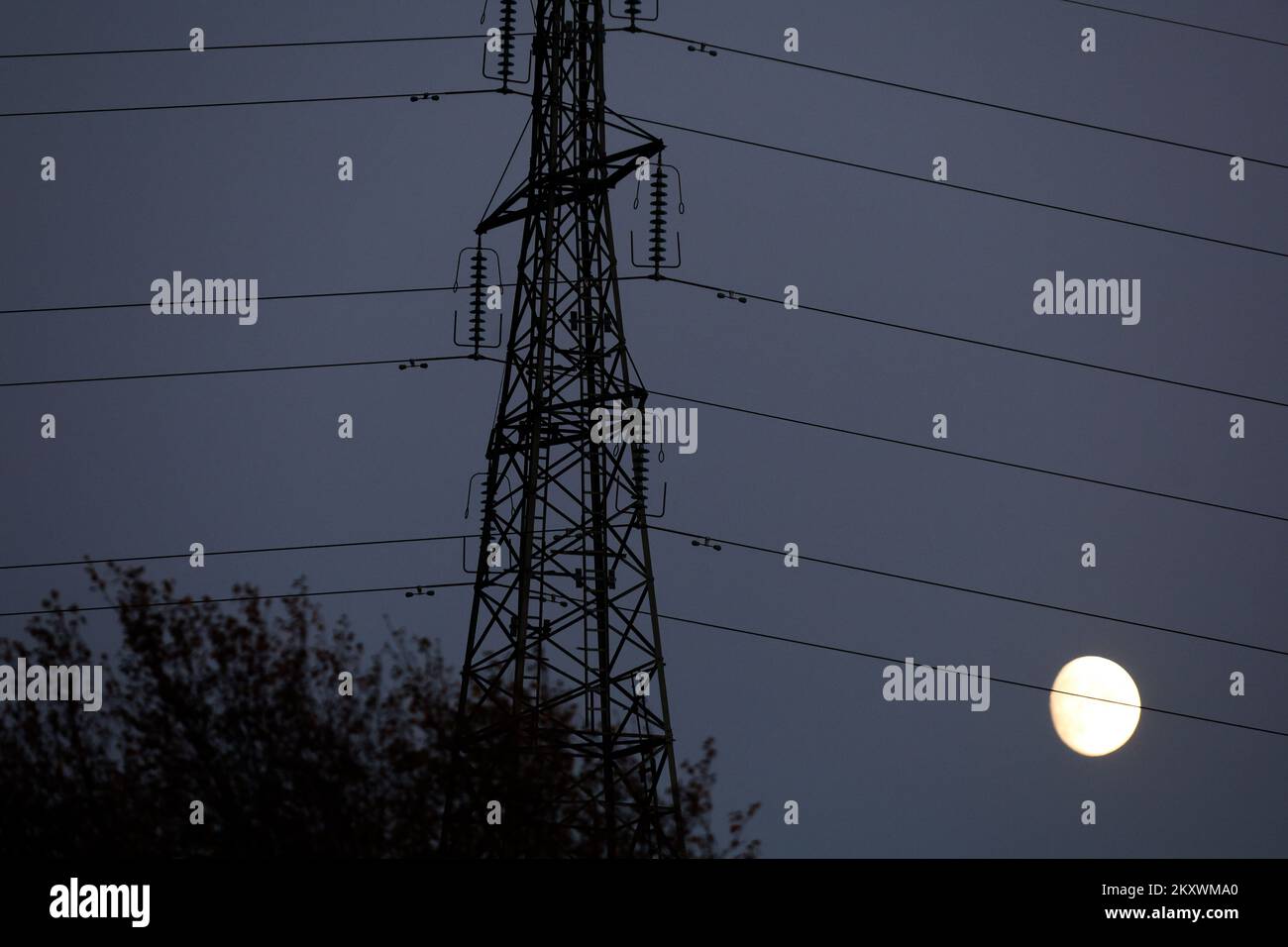 A electricity pylon and a full moon in Northern Ireland Stock Photo - Alamy