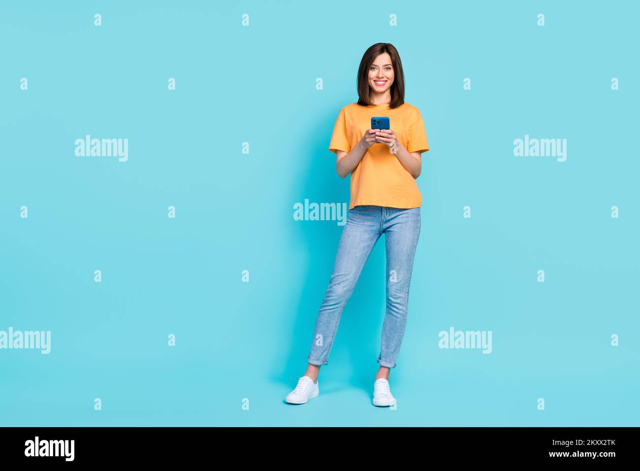 Full length photo of gorgeous cheerful person hold telephone telegram ...