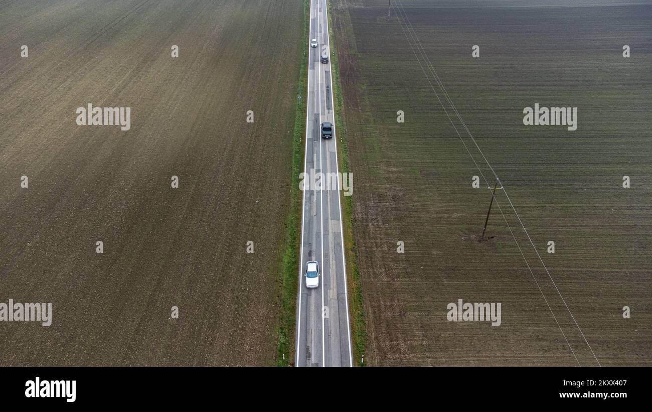 An aerial view shows cars drive along a road full of patches called 50 ...