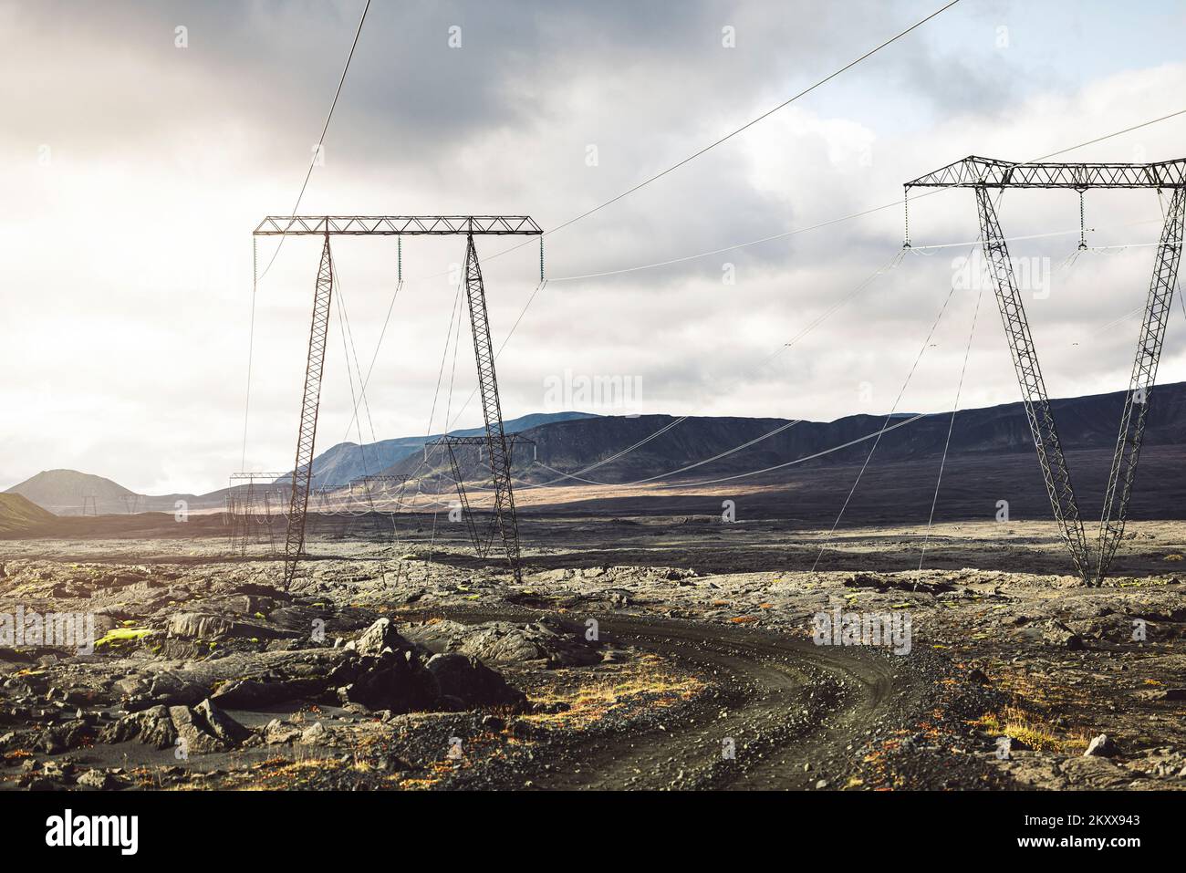 Sun peaking out from the clouds shining on electrical lines running ...