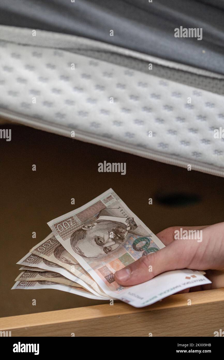 Kuna banknotes under the mattress to illustrate savings at home on ...