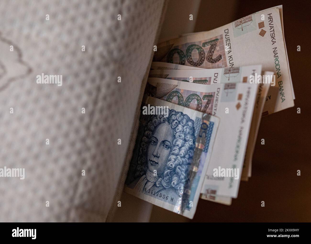 Kuna banknotes under the mattress to illustrate savings at home on ...