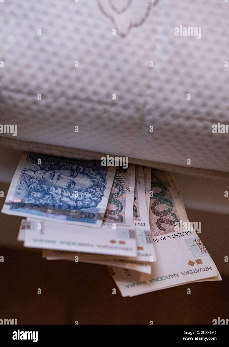 Kuna banknotes under the mattress to illustrate savings at home on ...
