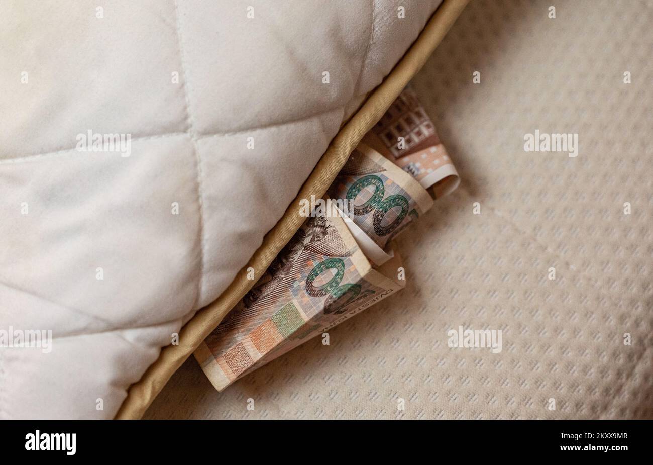 Kuna banknotes under the mattress to illustrate savings at home on ...