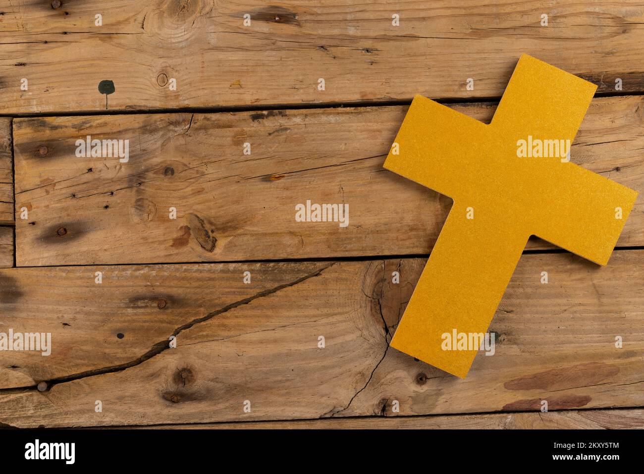 Composition of yellow cross and copy space on wooden background Stock ...