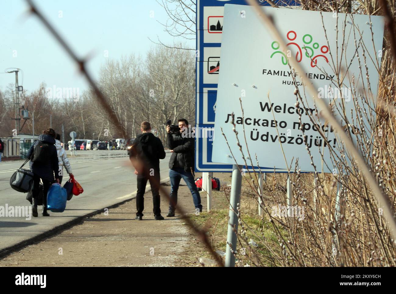 People wait at a border crossing as they flee from Ukraine to Hungary ...