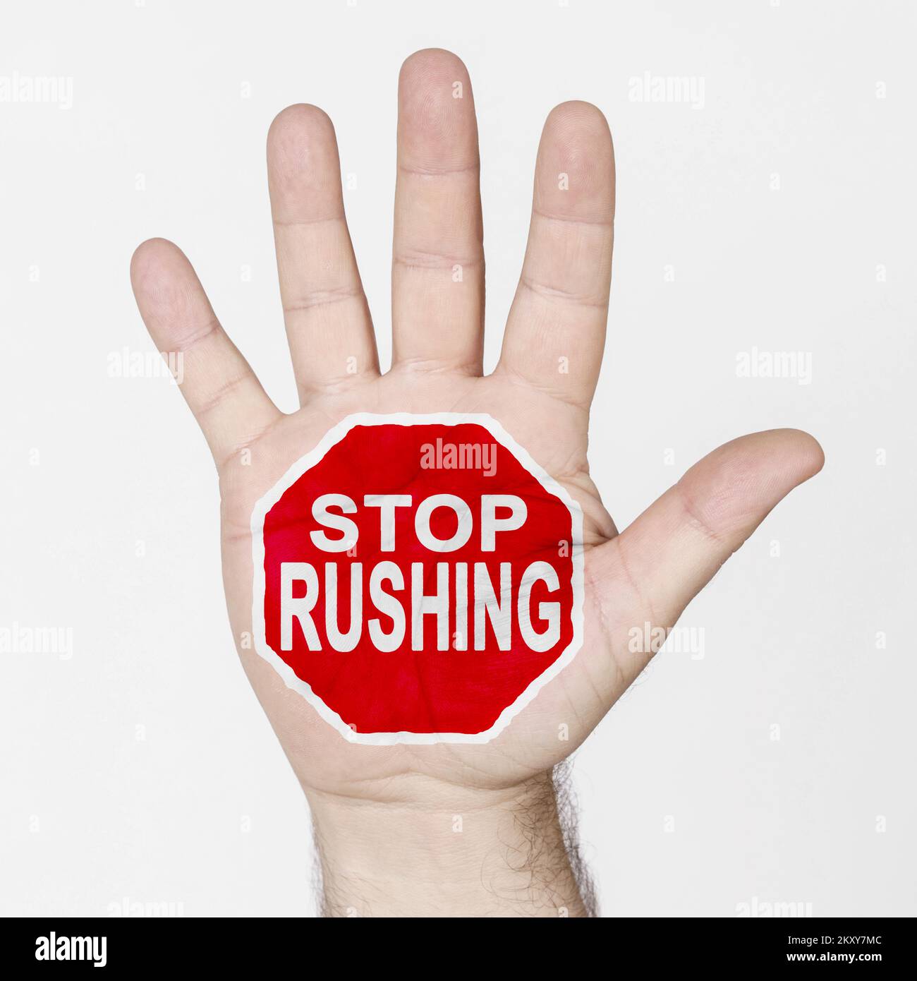 On the palm of the hand there is a stop sign with the inscription ...