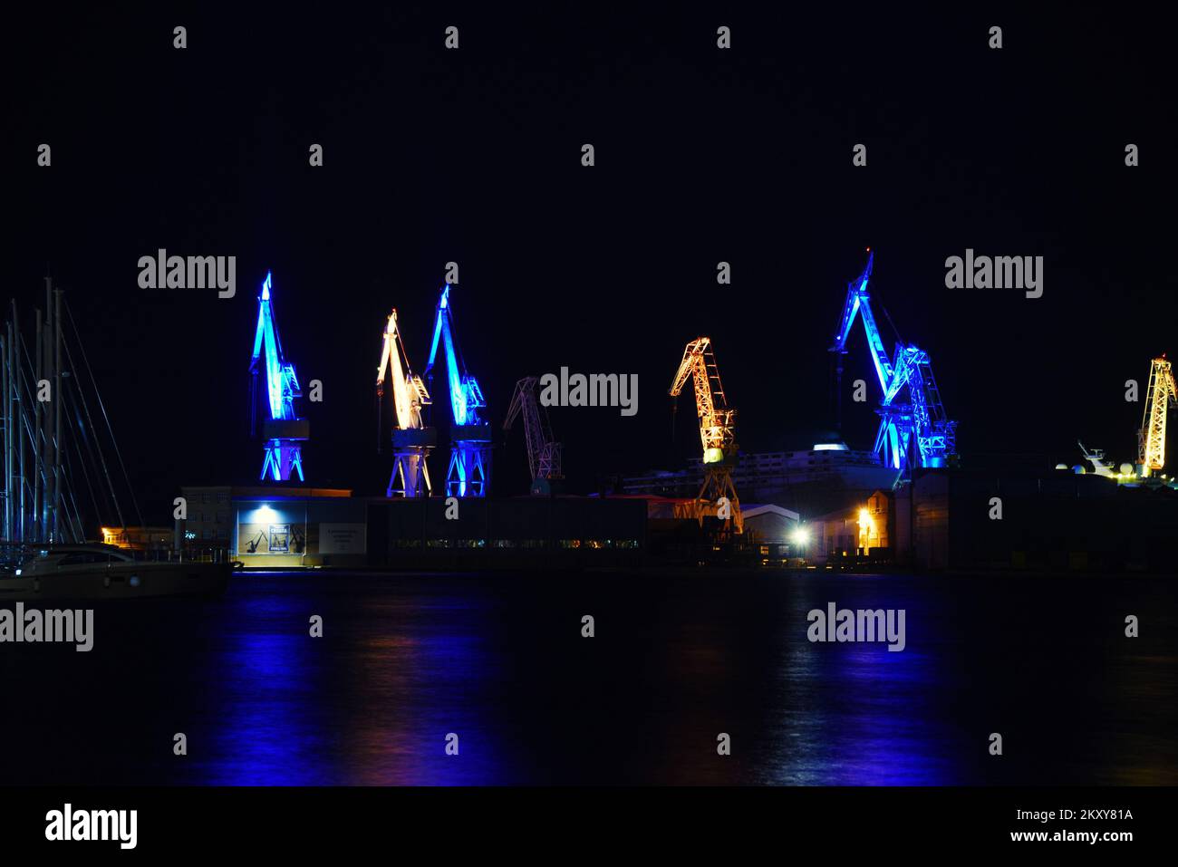 Cranes of the Pula shipyard Uljanik are illuminated in Ukrainian falg ...