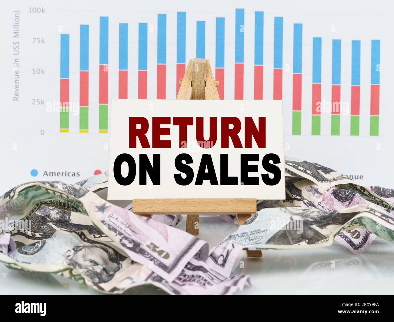 Business and finance concept. Among financial charts and money is a ...