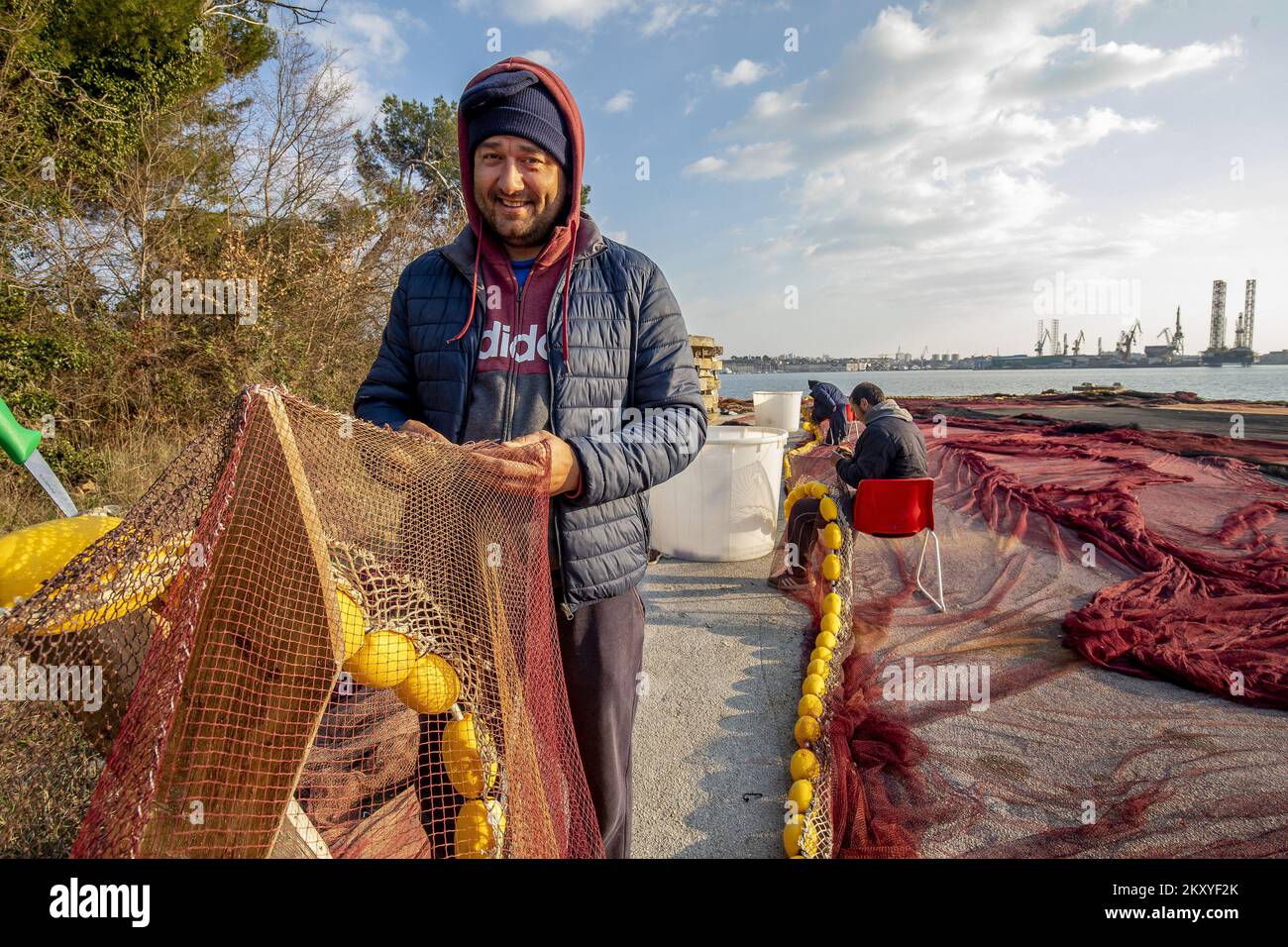 Fishermen use the time they are not at sea to repair torn nets in Pula ...