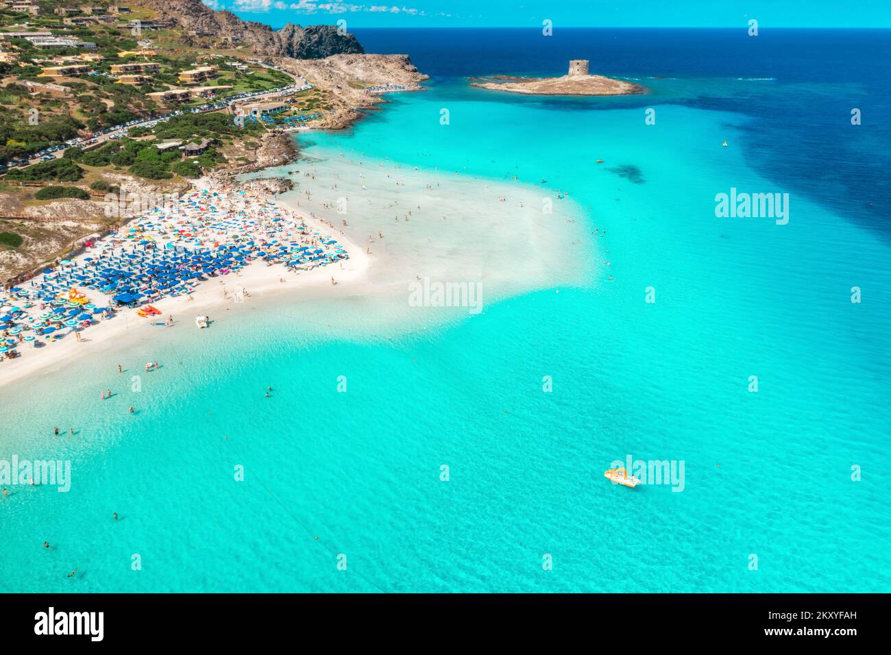 Aerial view of the white sand beach La Pelosa and swimming people in ...