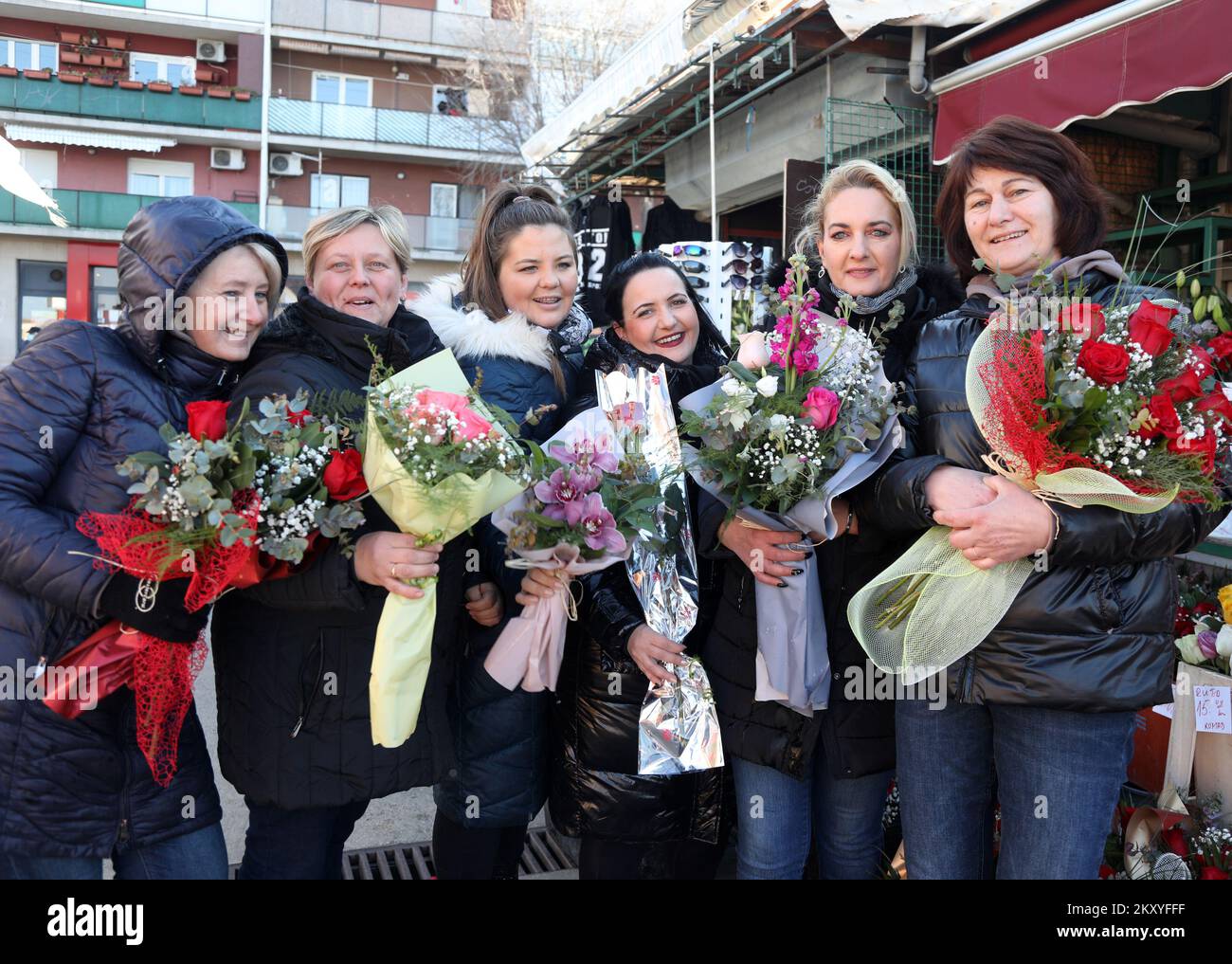 Women holding a flowers pose for photo as International Women's Day ...