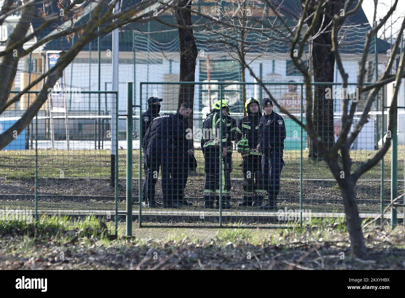 A cargo parachute stuck on the treetops at the crash site. Police are ...