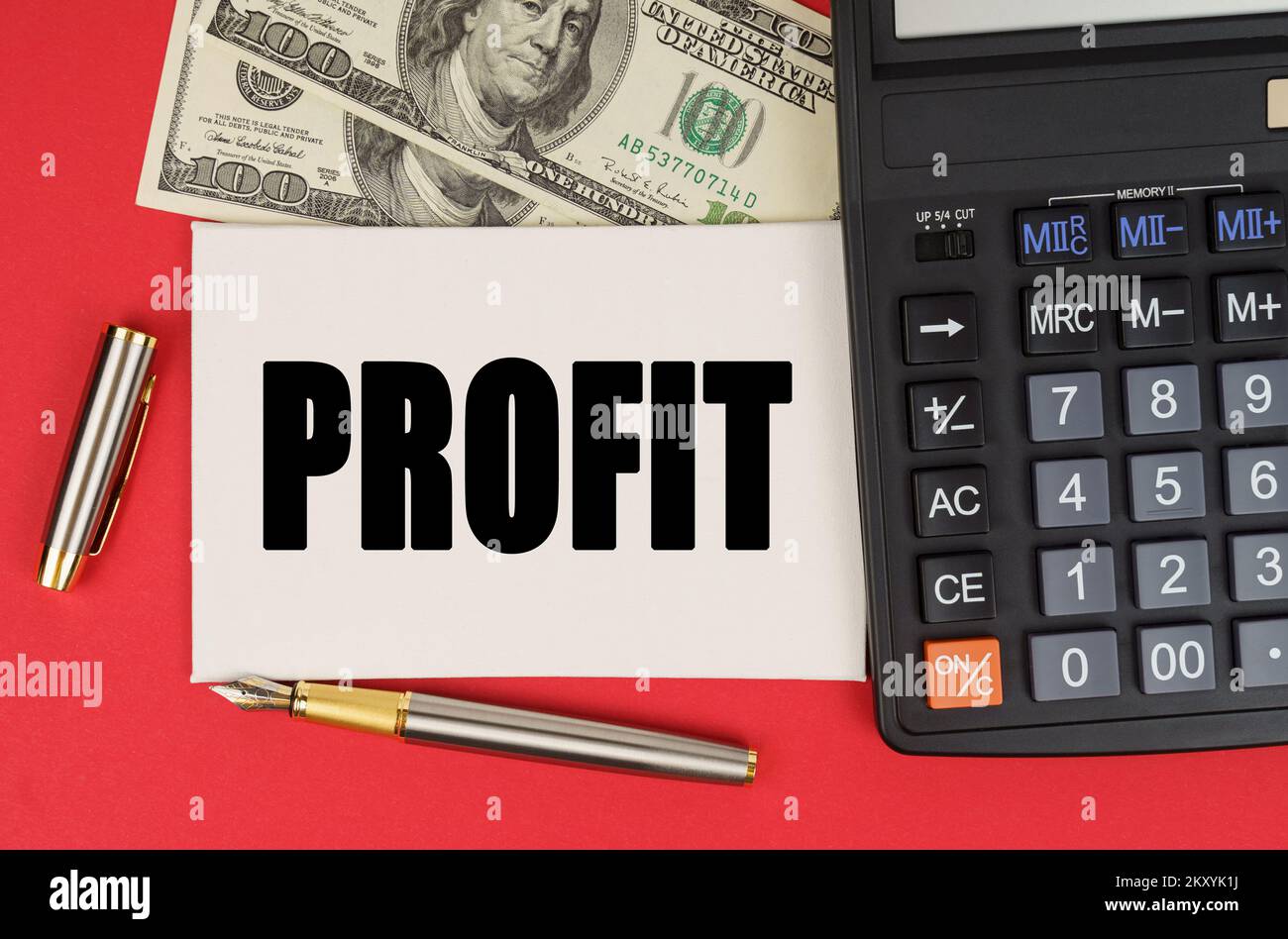 Business and finance concept. On a red background, among the money, a ...