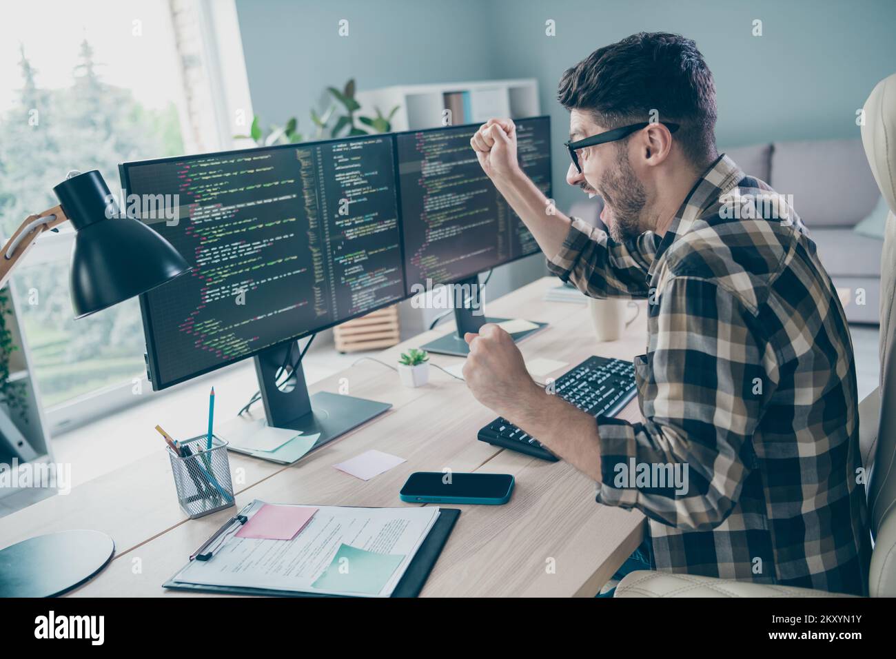 Photo of lucky happy programmer wear spectacles rising fists successful ...