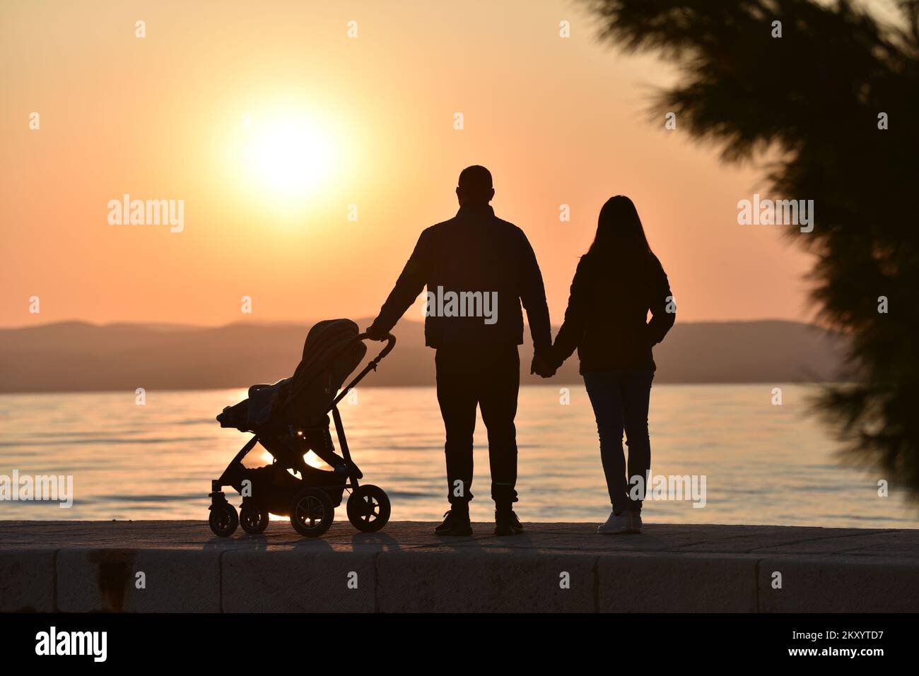 Happy young family enjoys walking and sunset in Makarska, Croatia on ...