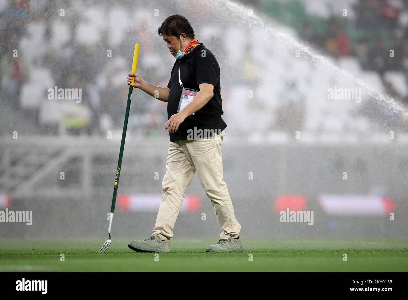 Ground staff prepare the pitch as sprinklers off ahead the ...