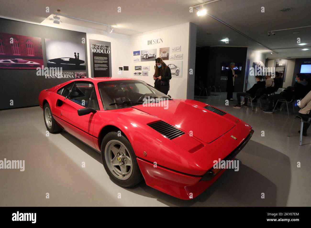 A woman looks at the 1980 Ferrari 308 GTR during La Grande Bellezza ...