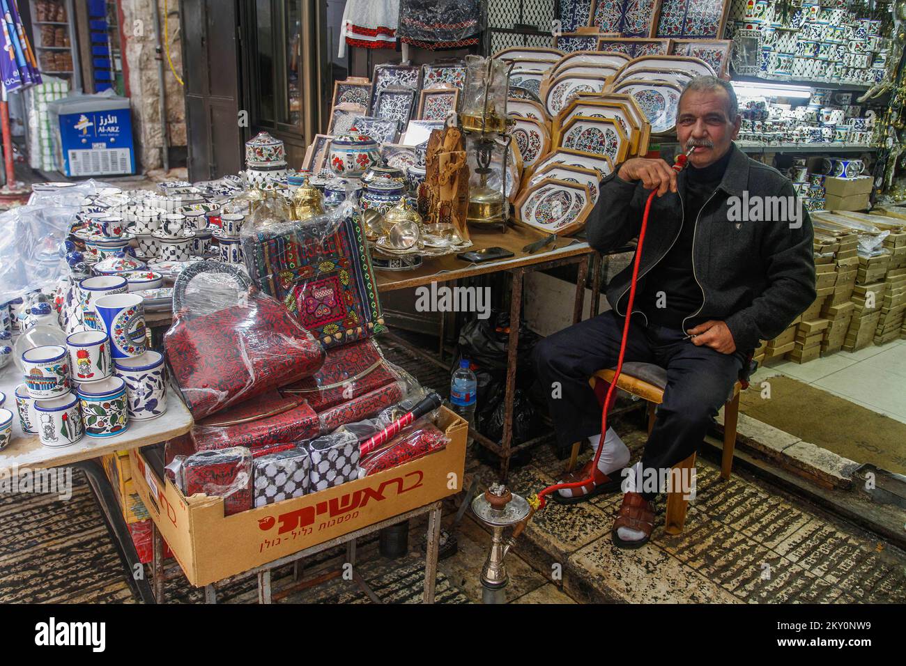 A shopkeeper waits for customers in his shop at an antiques market in ...