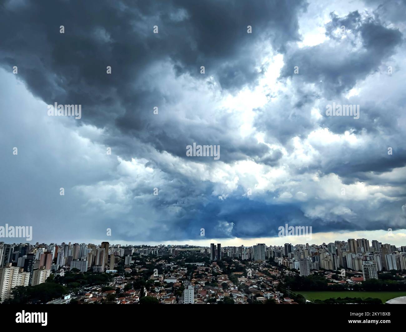 Dark and dramatic rain clouds over a city Stock Photo - Alamy