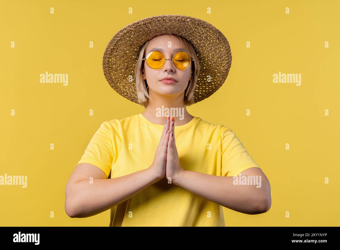 Cute woman praying, begs to apologize her, she is guilty. Yellow ...