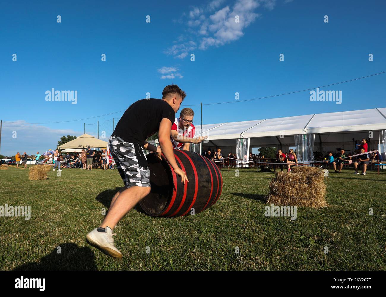 Participants push a barrel during Village games in Paukovec Village ...