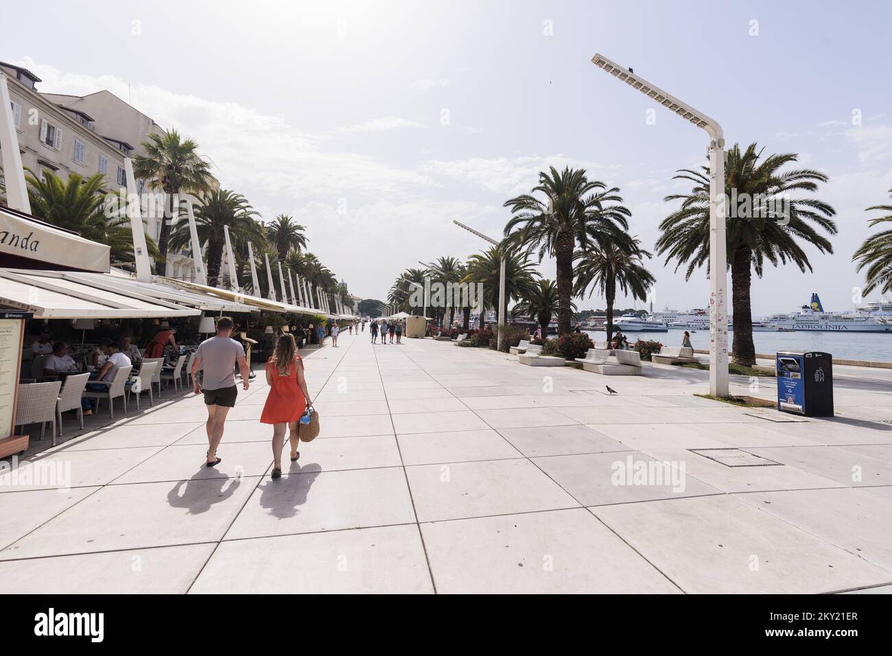People walking along the Riva , Split's famous waterfront promenade ...