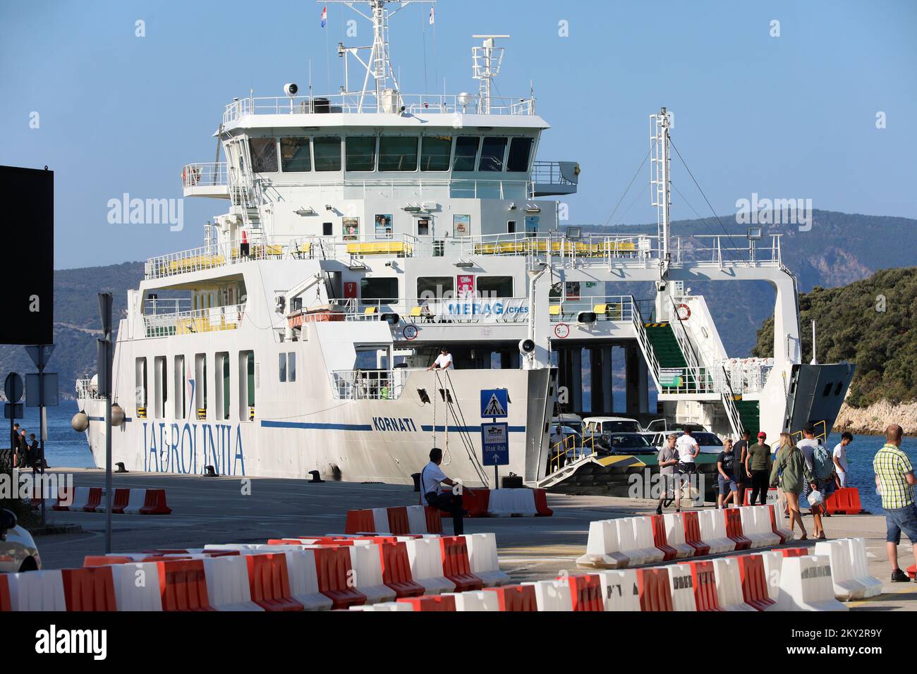 Tourists board the Jadrolinija Kornati and Ilovik ferries at the ...